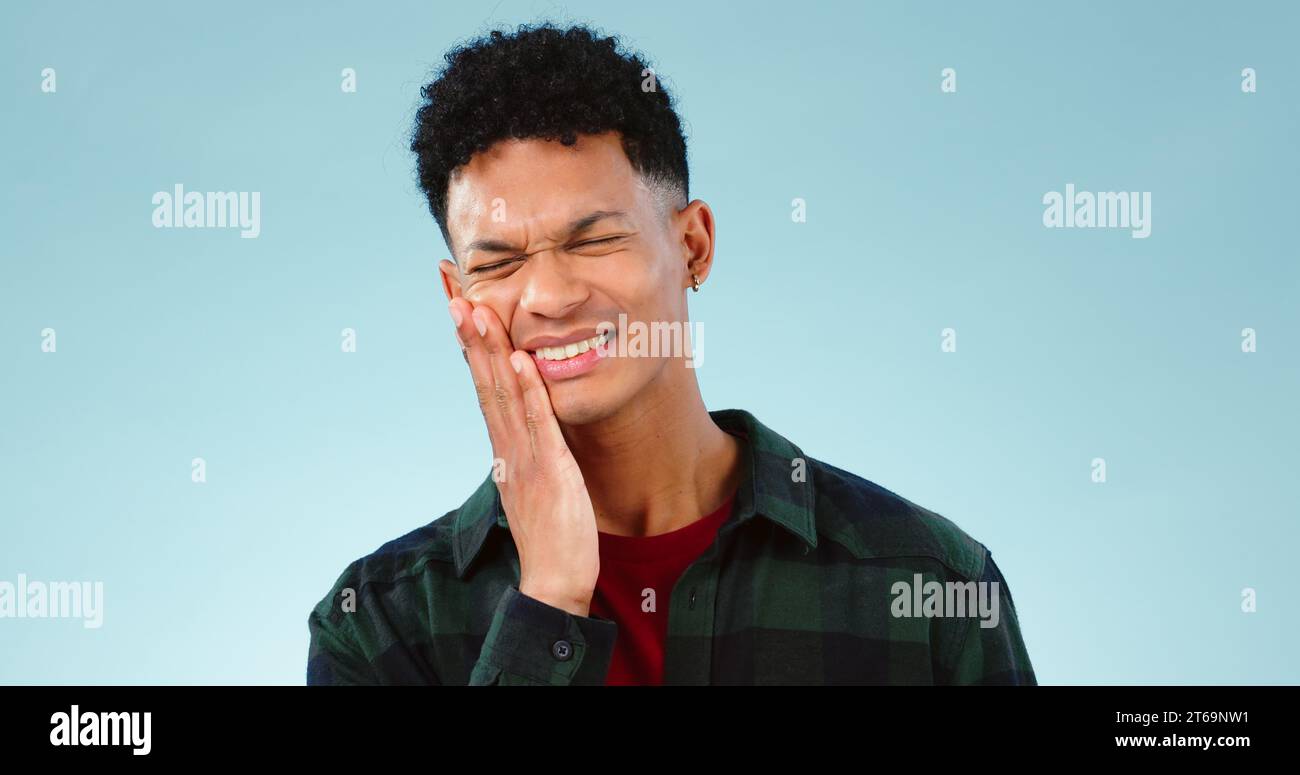 Man, toothache or pain in studio with gum problem, cavity or dental ...