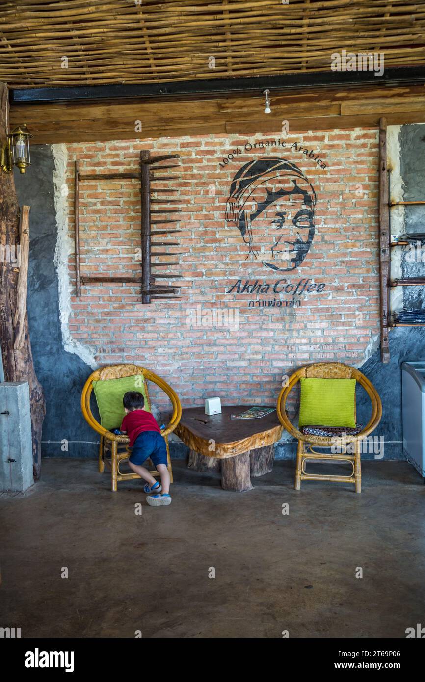 Logo painted on brick wall at the Akha Cottage restaurant and coffee ...