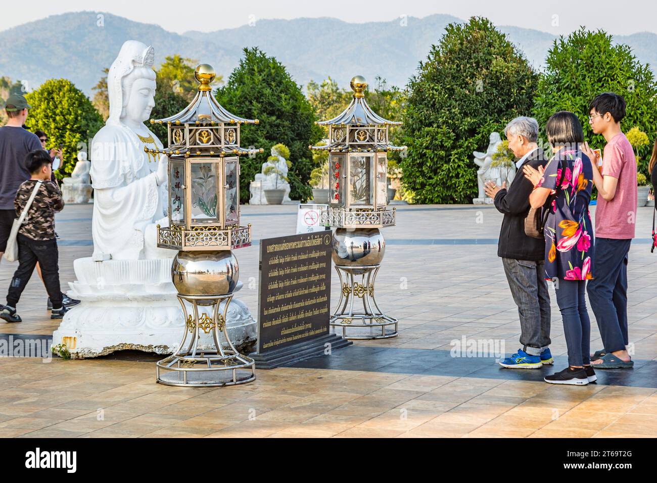 Visitors praying at the Guan Yin (Goddess of Mercy) statue at Wat Huay ...