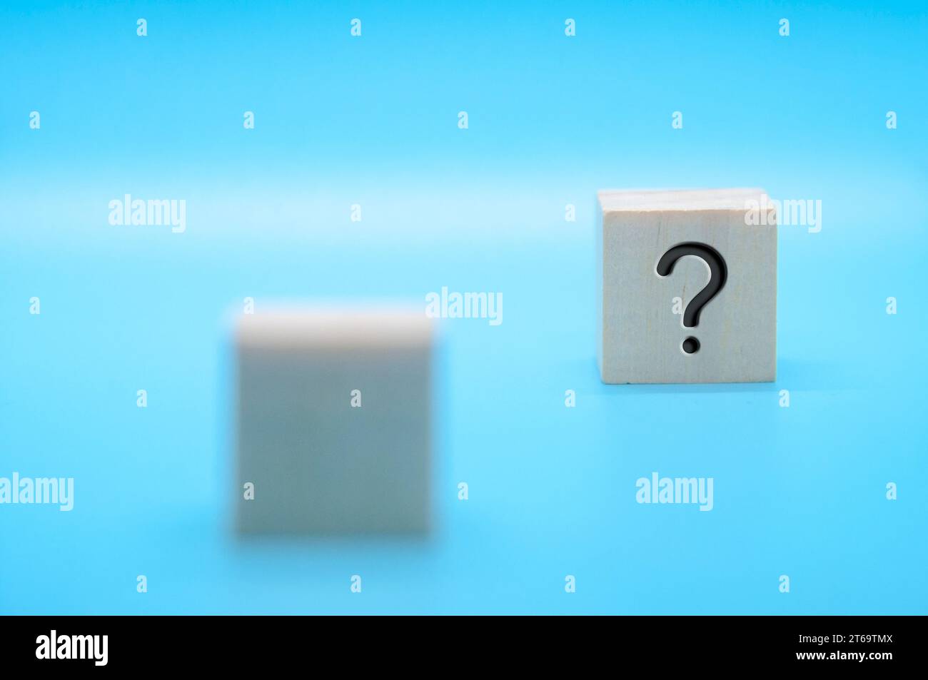 Question mark on wooden block with blue background. Question and answer ...