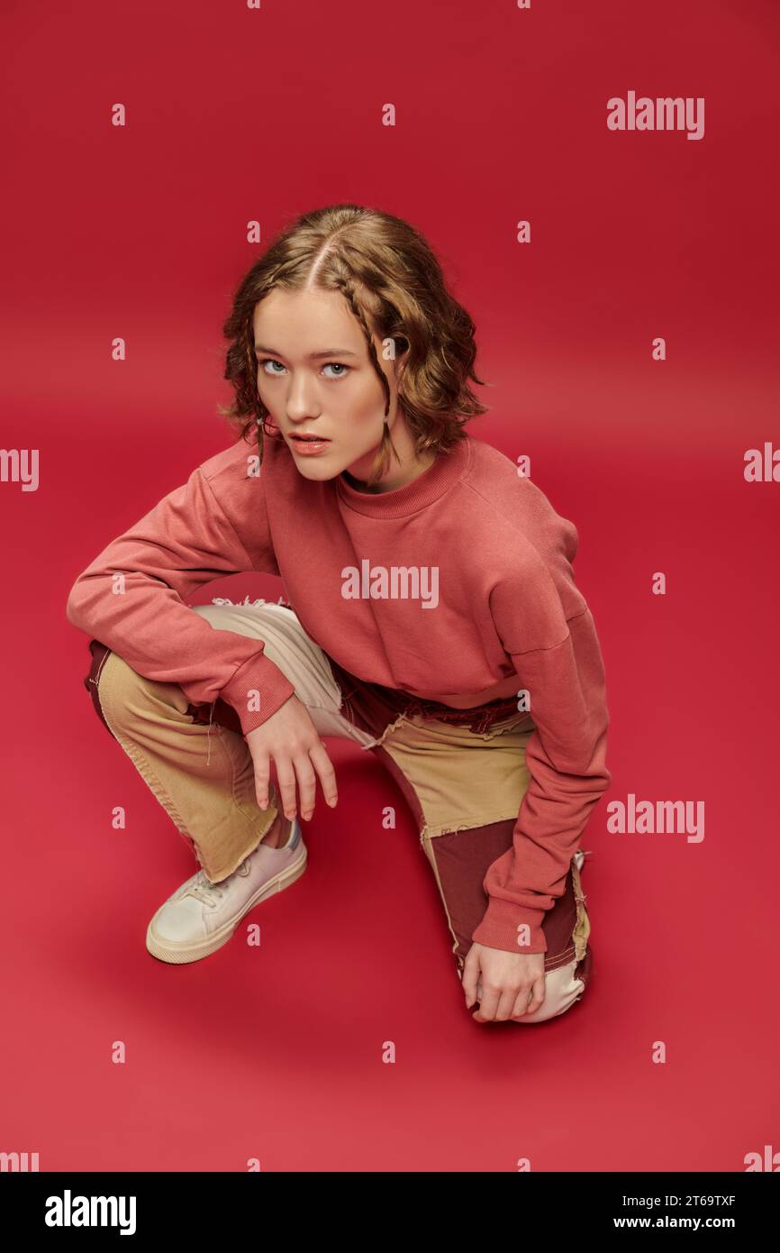 overhead view, stylish gen z girl in patchwork pants and cropped long ...