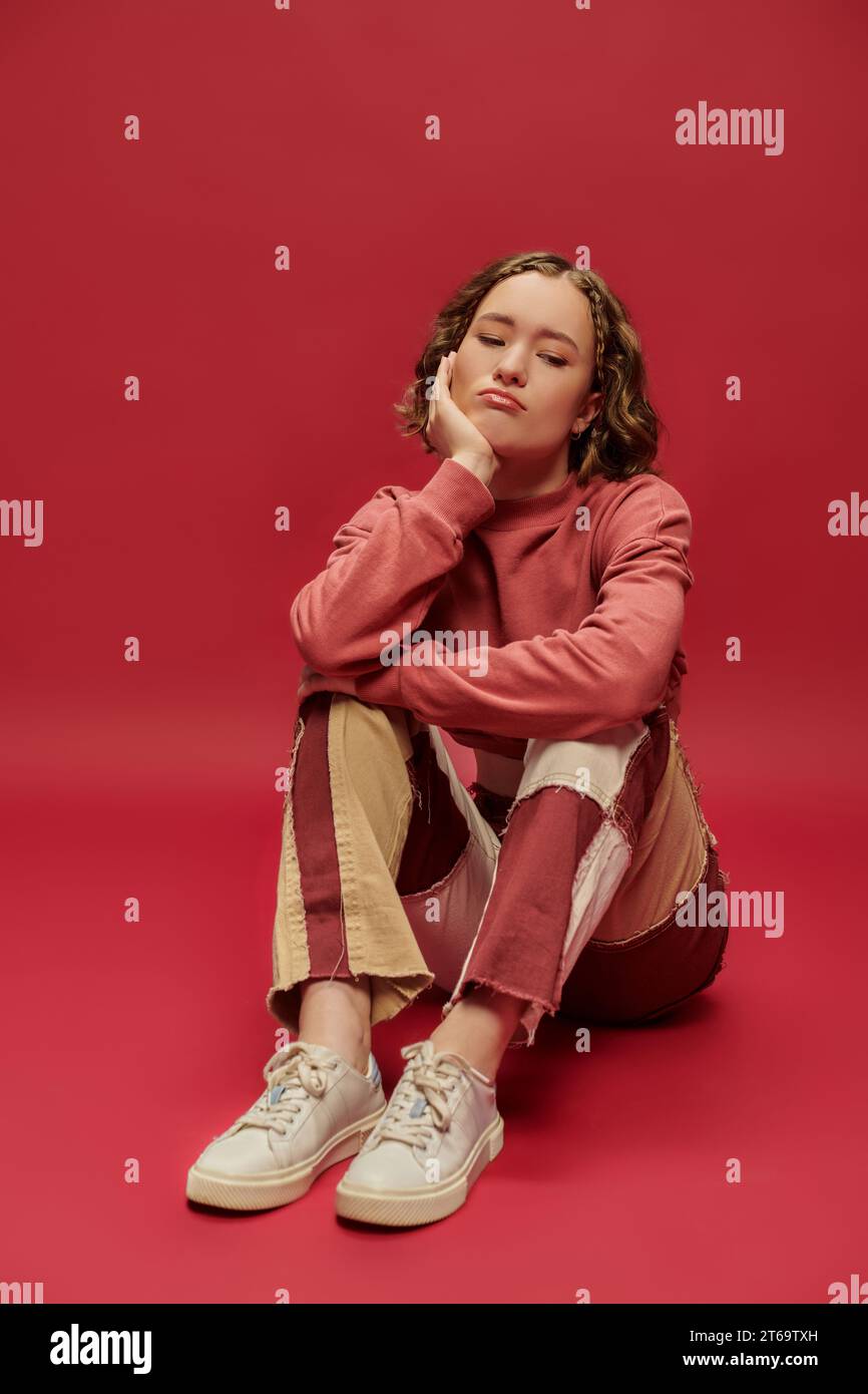 bored and stylish gen z girl in patchwork pants and cropped long sleeve ...