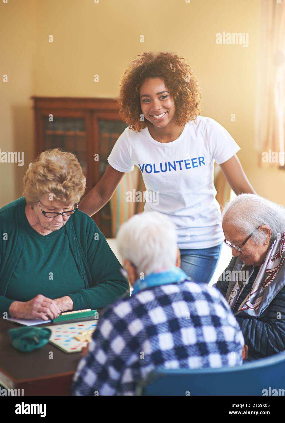 She enjoys giving a helping hand. a volunteer working with seniors at a ...