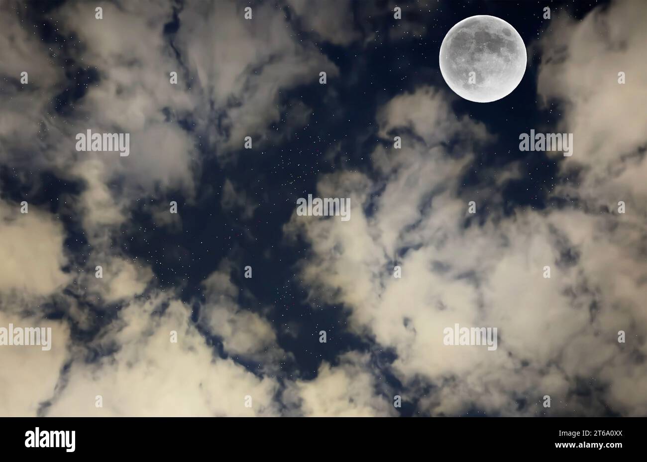 Hunter's full moon in October glowing among the clouds in the night sky ...