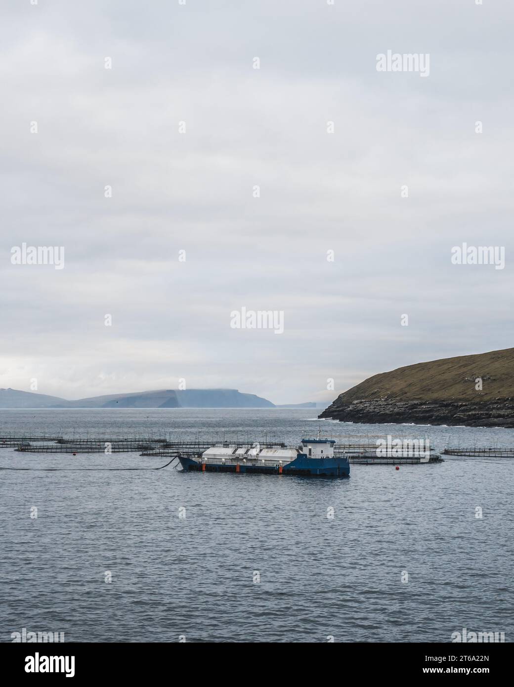 A ship in the salmon farm, fish farming industry Faroe Islands ...
