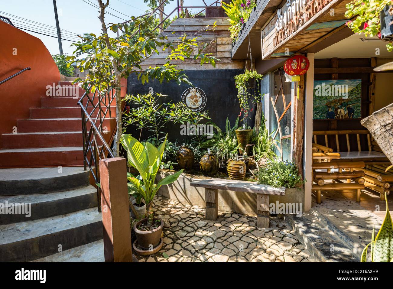 Stairs lead down to the Doi Phamee coffee shop and restaurant in Mae ...