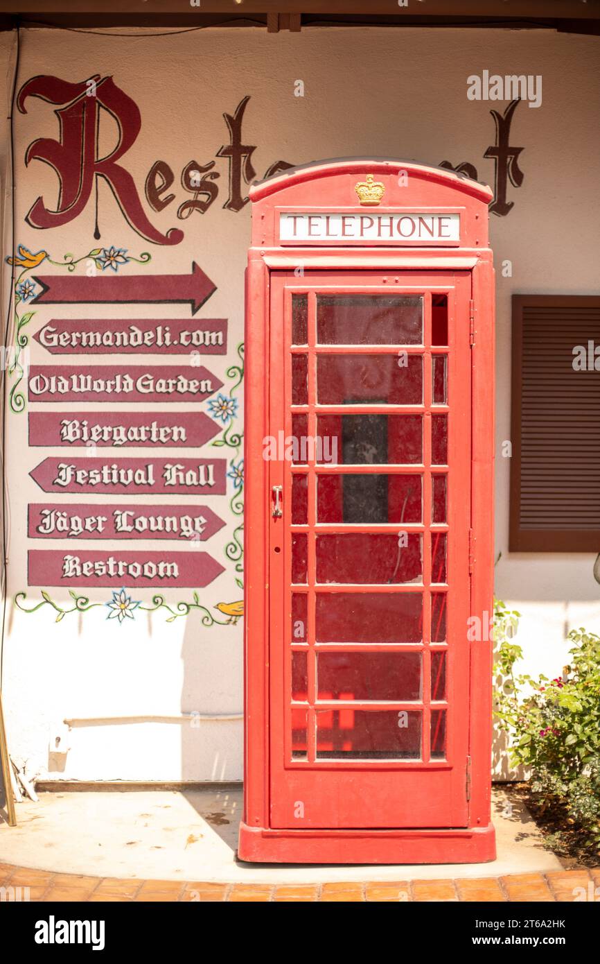 An iconic red telephone booth stands in contrast to the large modern ...
