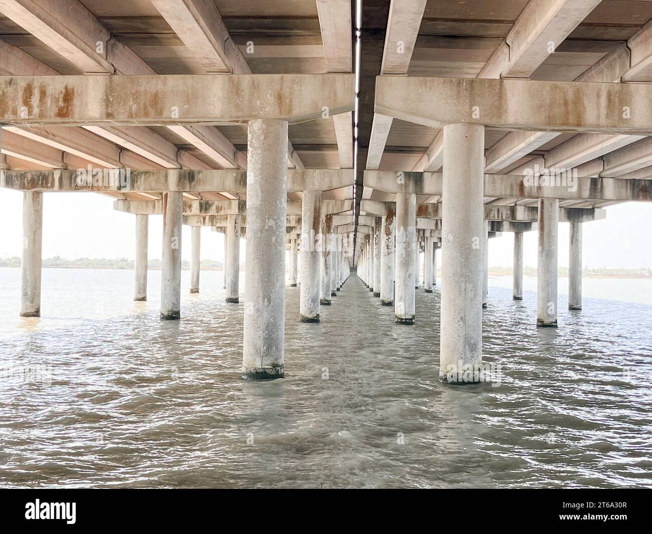 Aerial view of a large bridge with multiple boats navigating underneath ...