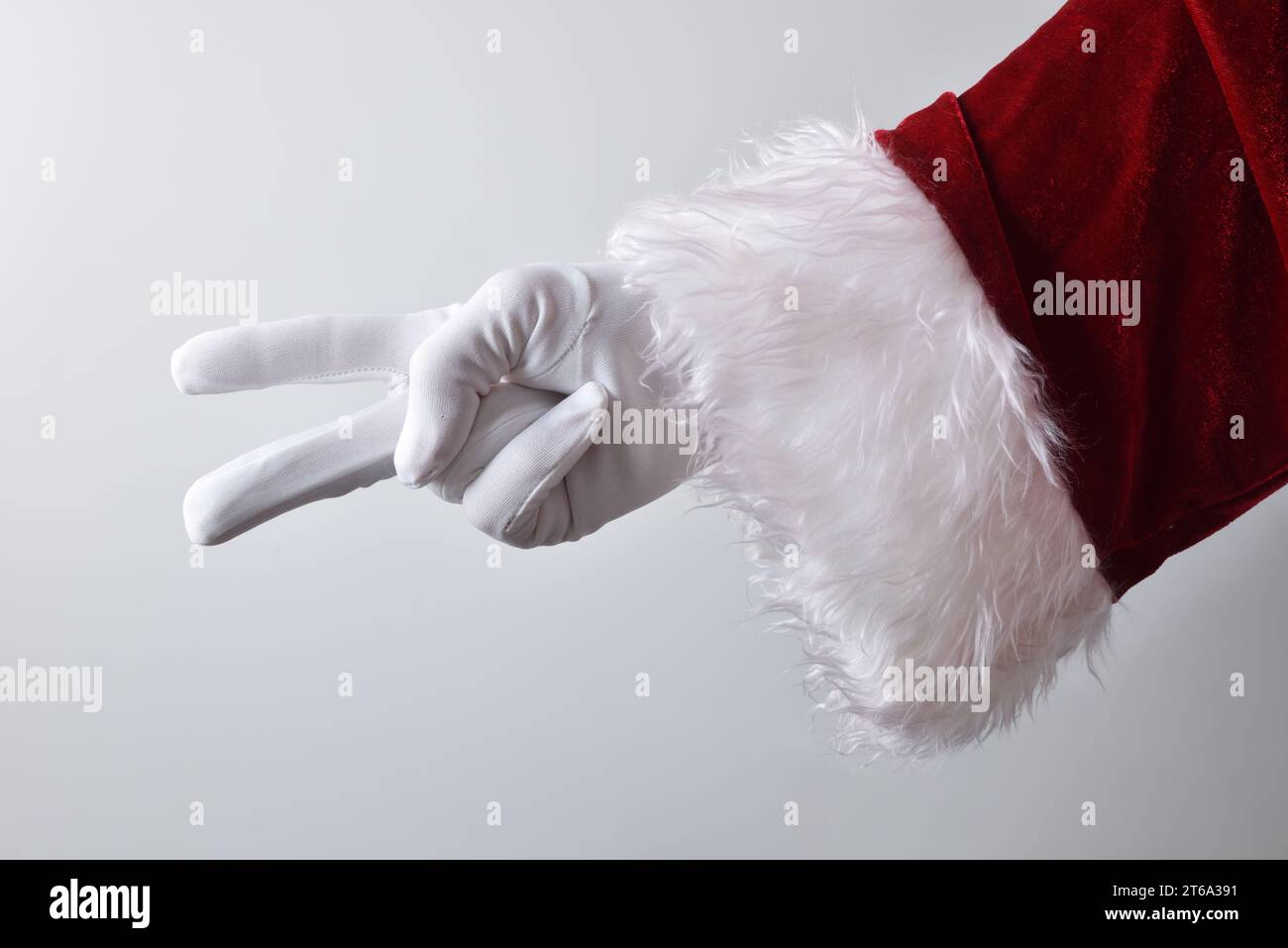 Detail of santa claus hand showing two fingers with white gloves ...