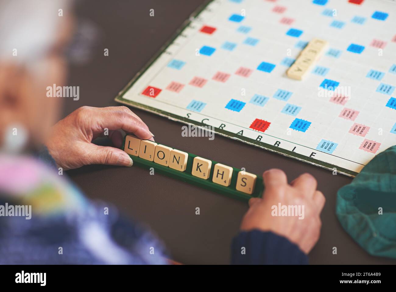 Spell Winning. seniors playing a boardgame Stock Photo - Alamy