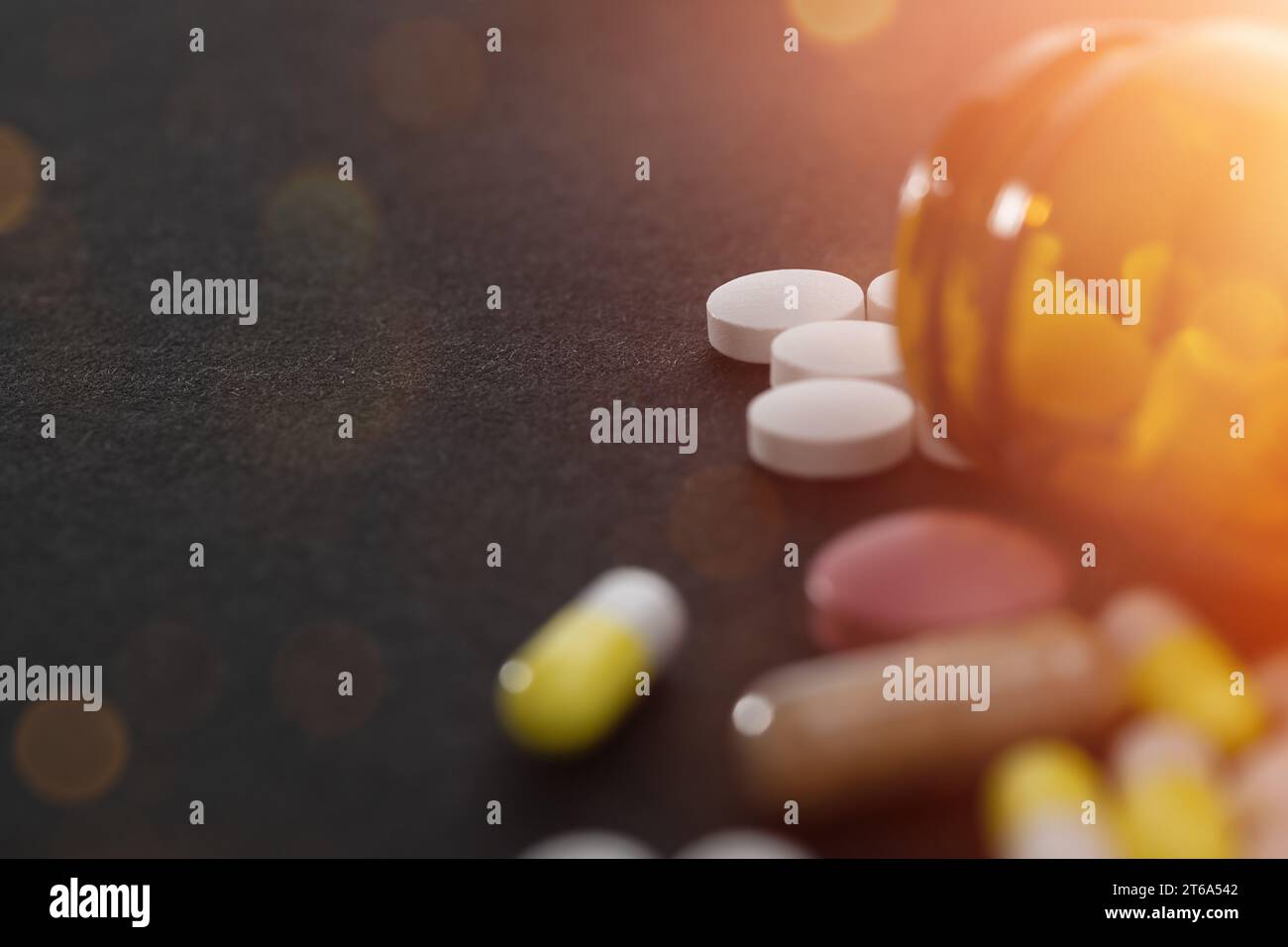 Various pills spilling out of a bright red orange pill bottle Stock ...