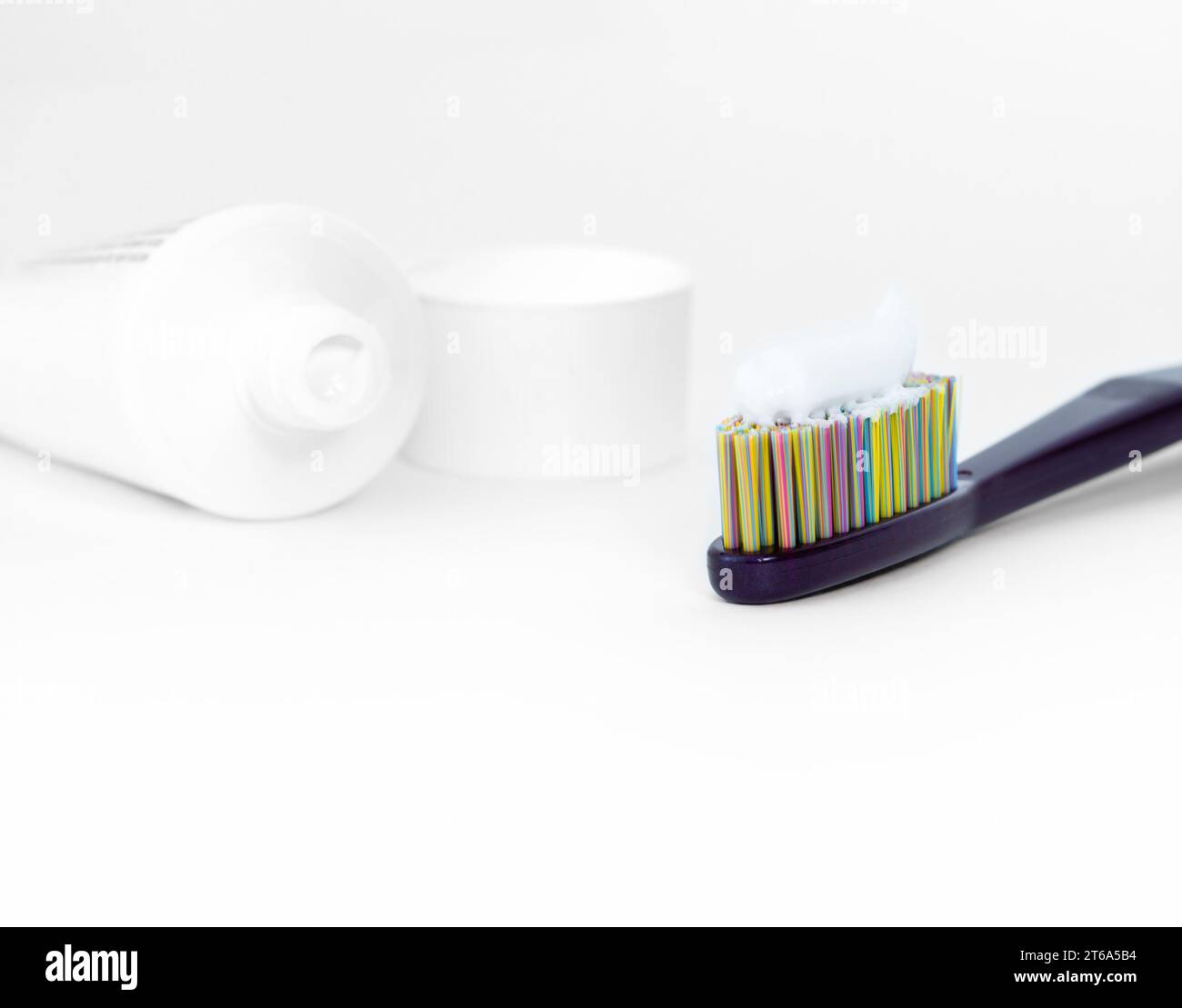 Toothbrush with white toothpaste on white background Stock Photo - Alamy