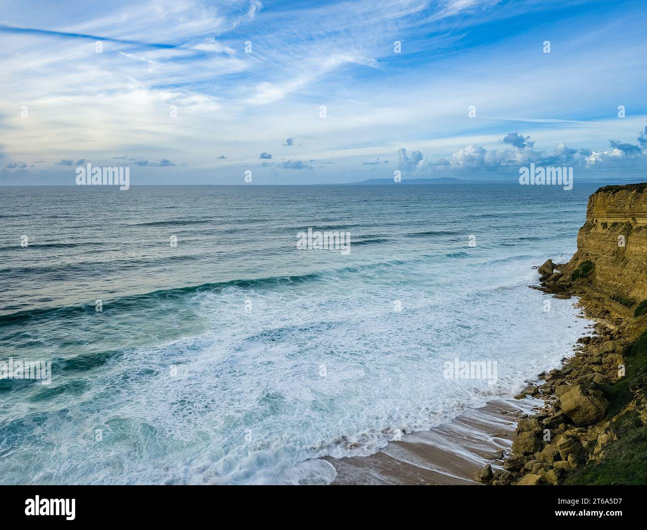 A scenic landscape featuring a dramatic cliffside overlooking a ...