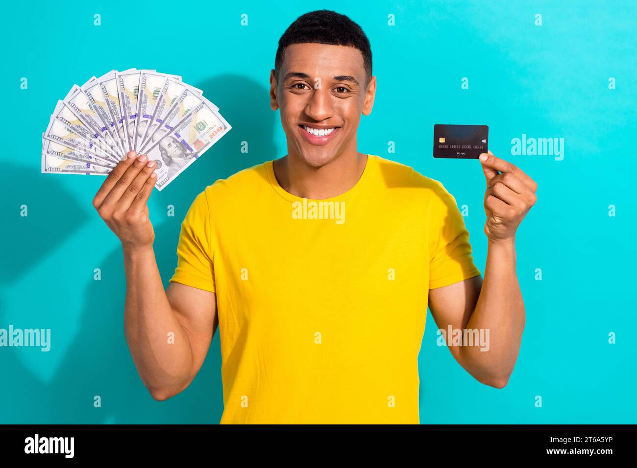 Photo of successful nice person toothy smile hands hold showing dollar ...