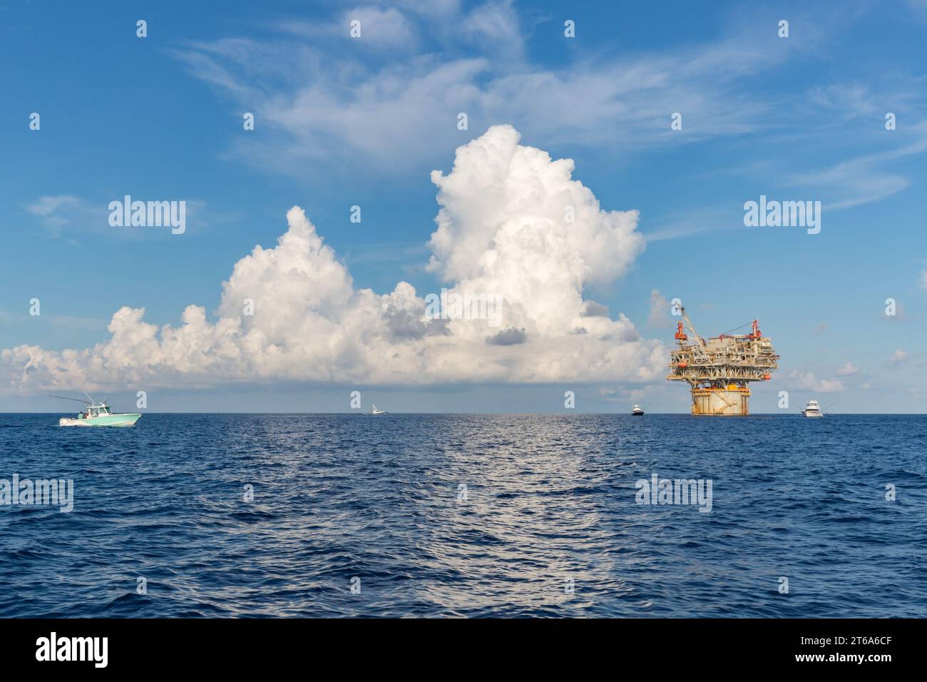 Offshore private fishing boats near an offshore petroleum drilling rig ...