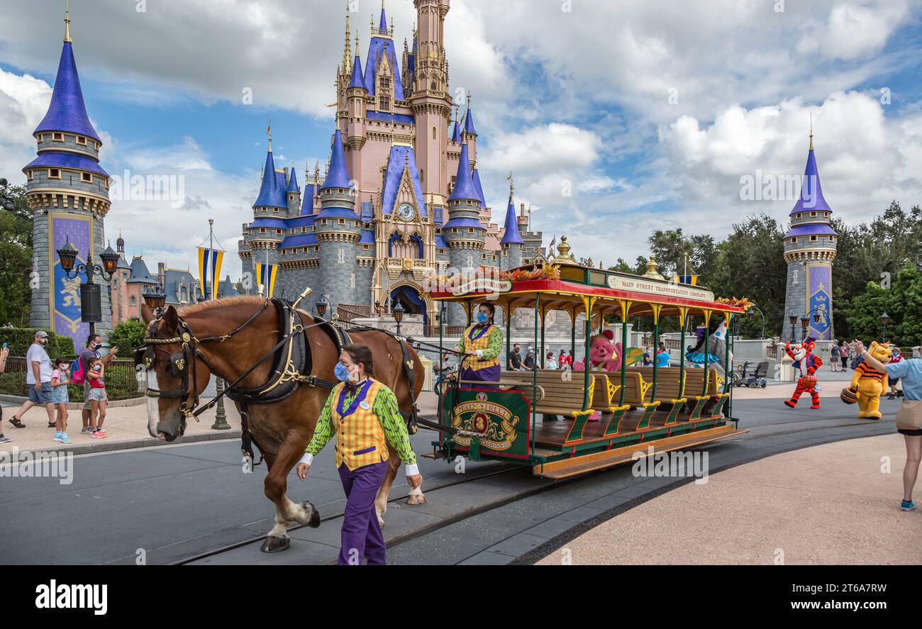 Piglet character rides a horse drawn trolley past Cinderella's Castle ...