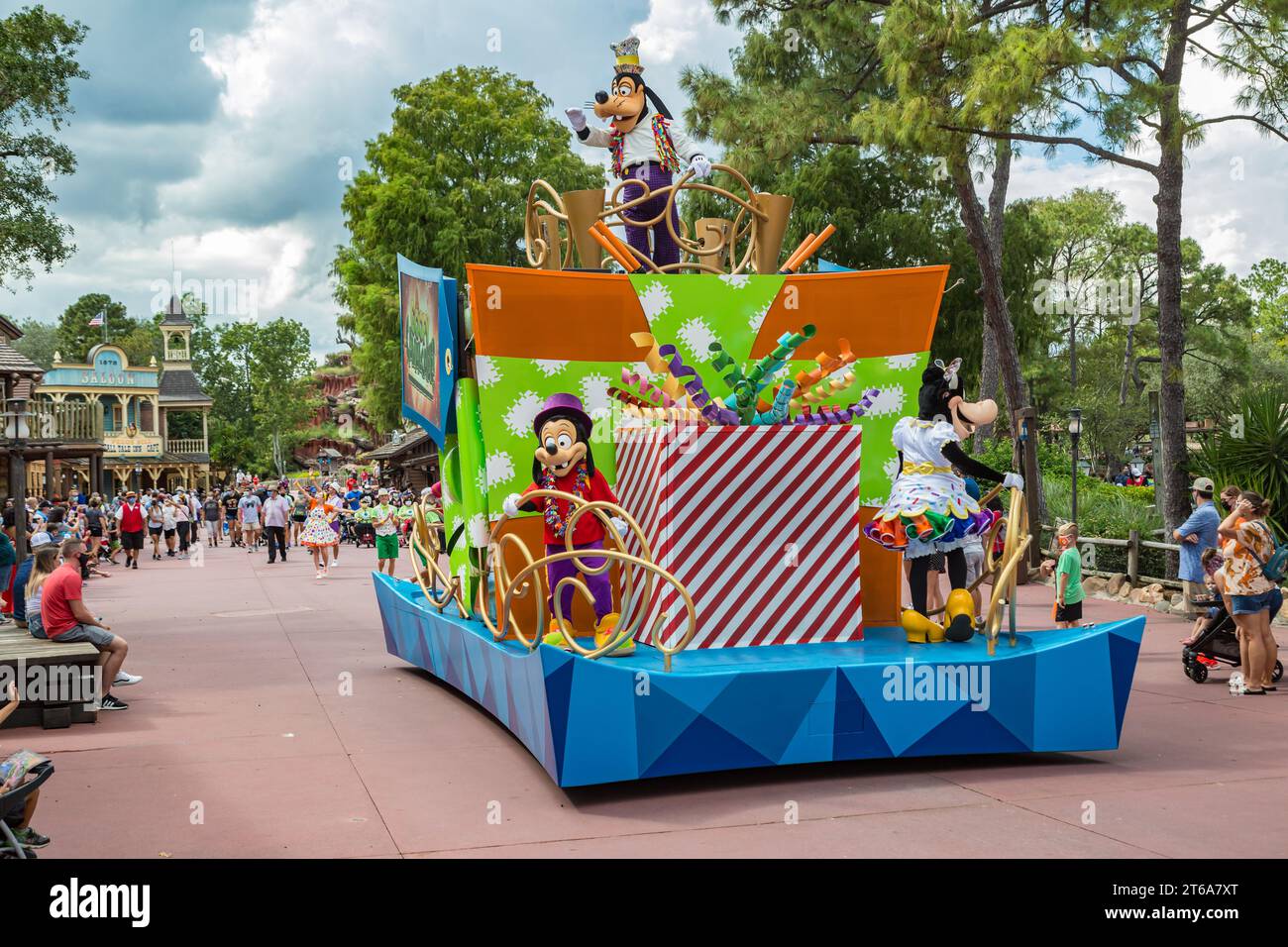 Disney characters riding on float during parade through the ...
