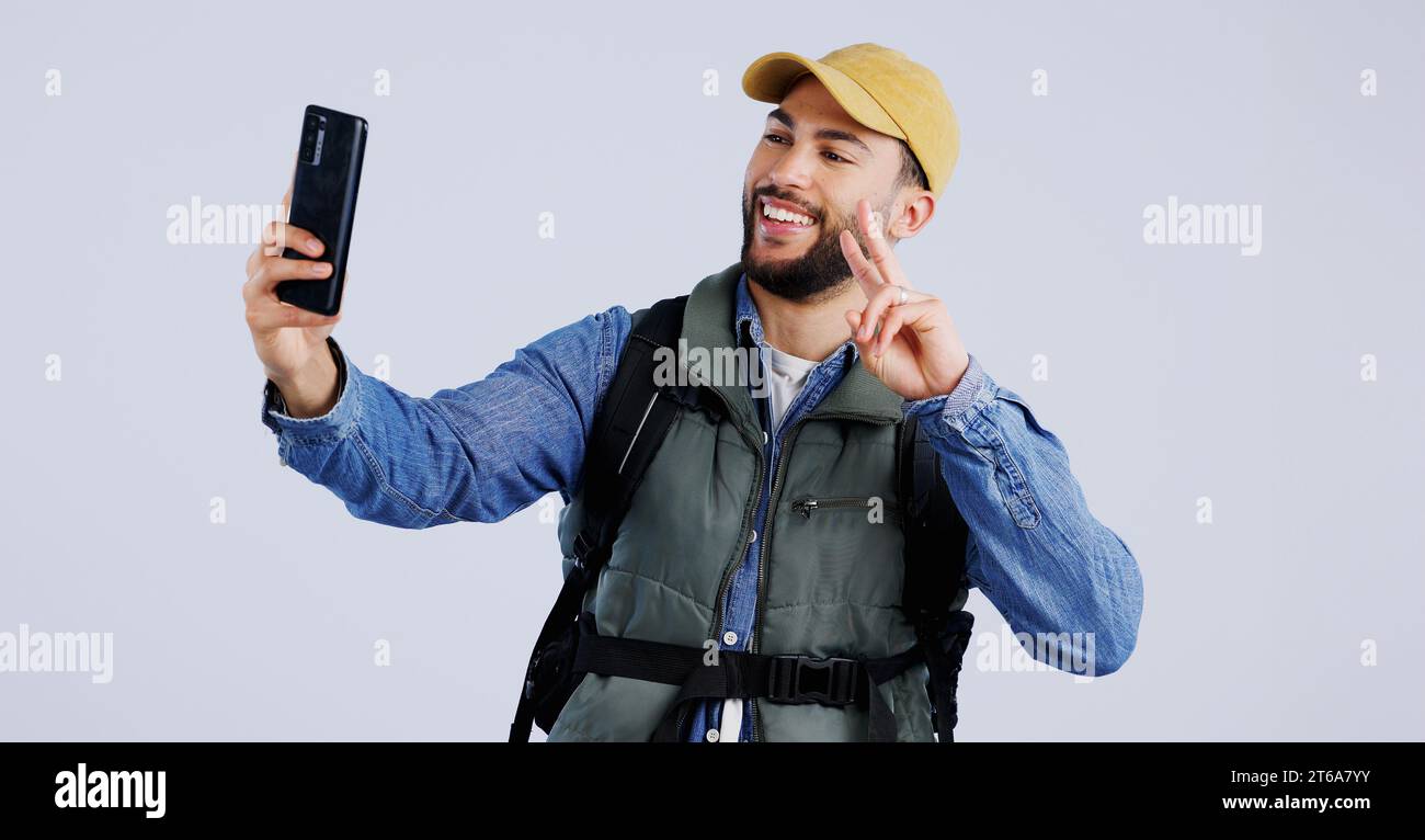 Hiking, smile and man with selfie, peace sign and social media with fun ...