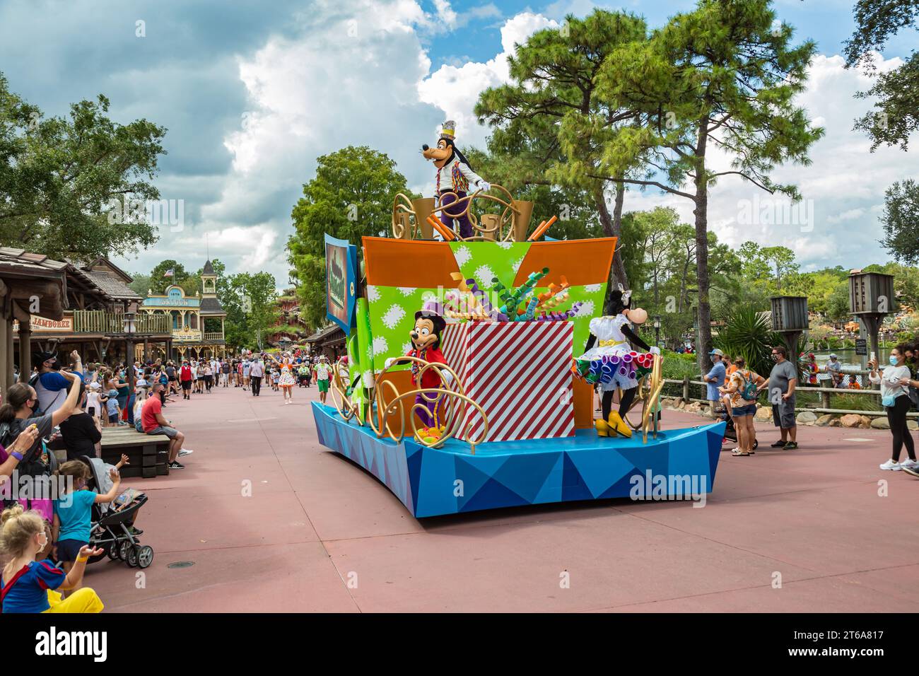 Disney characters riding on float during parade through the ...