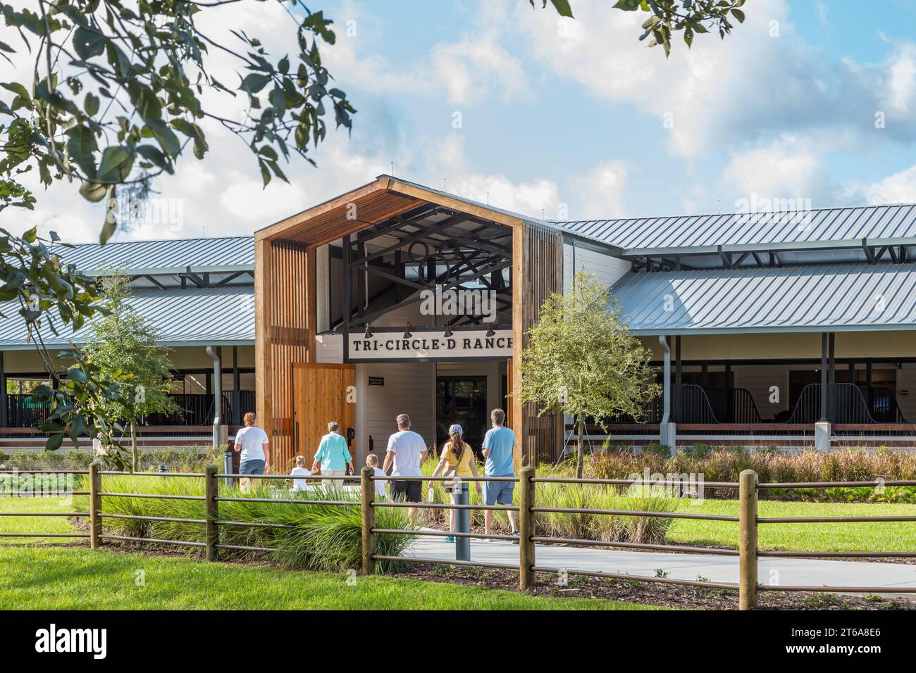 Family entering the Tri-Circle-D Ranch horse stables in the Fort ...