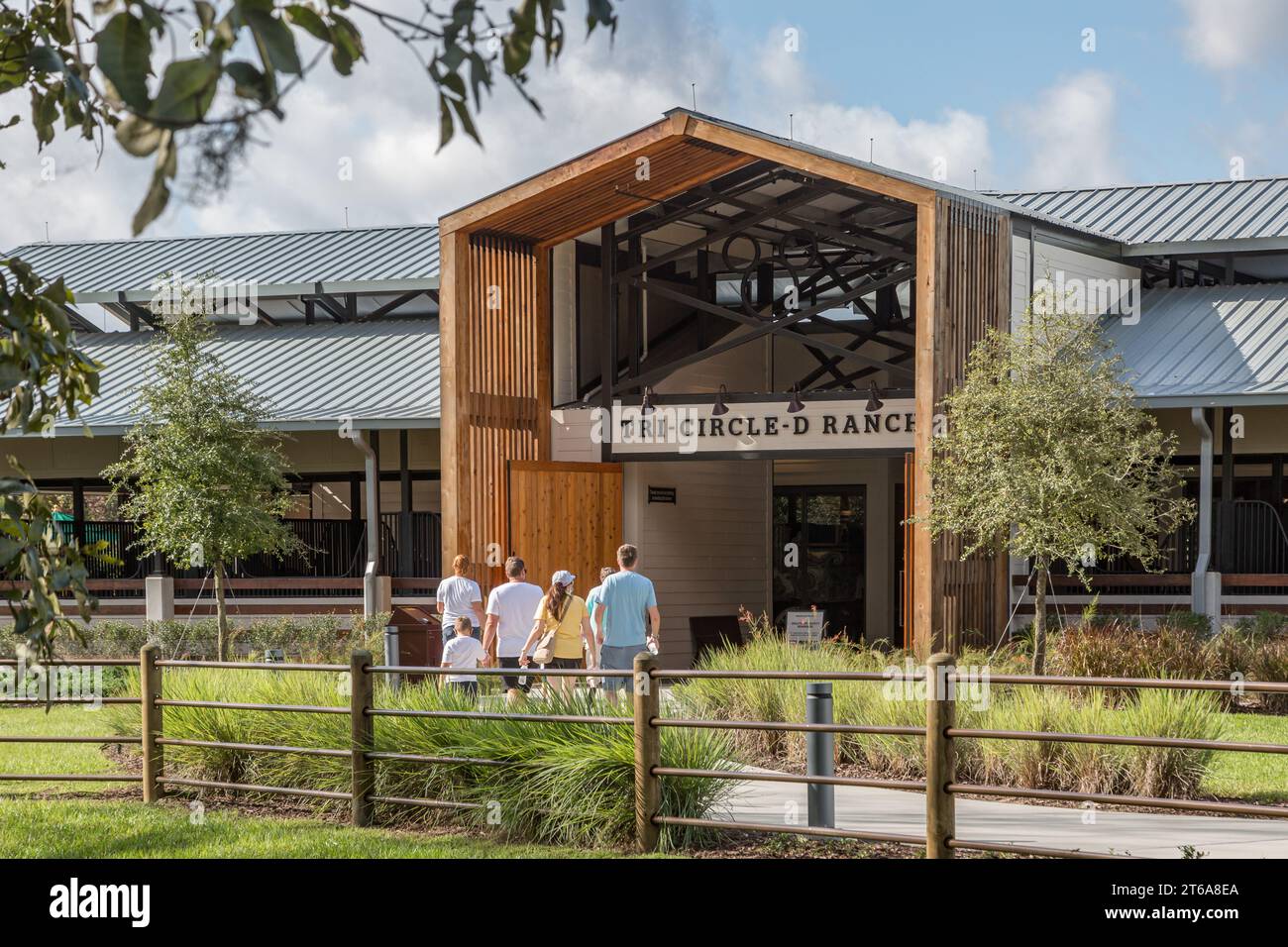 Family entering the Tri-Circle-D Ranch horse stables in the Fort ...