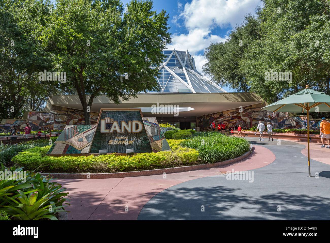 Family and senior couple entering The Land attraction in Epcot at Walt ...