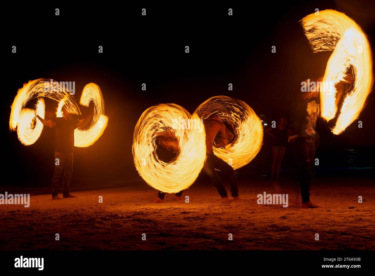 Fire three ways. a fire performance on a beach in Thailand Stock Photo ...