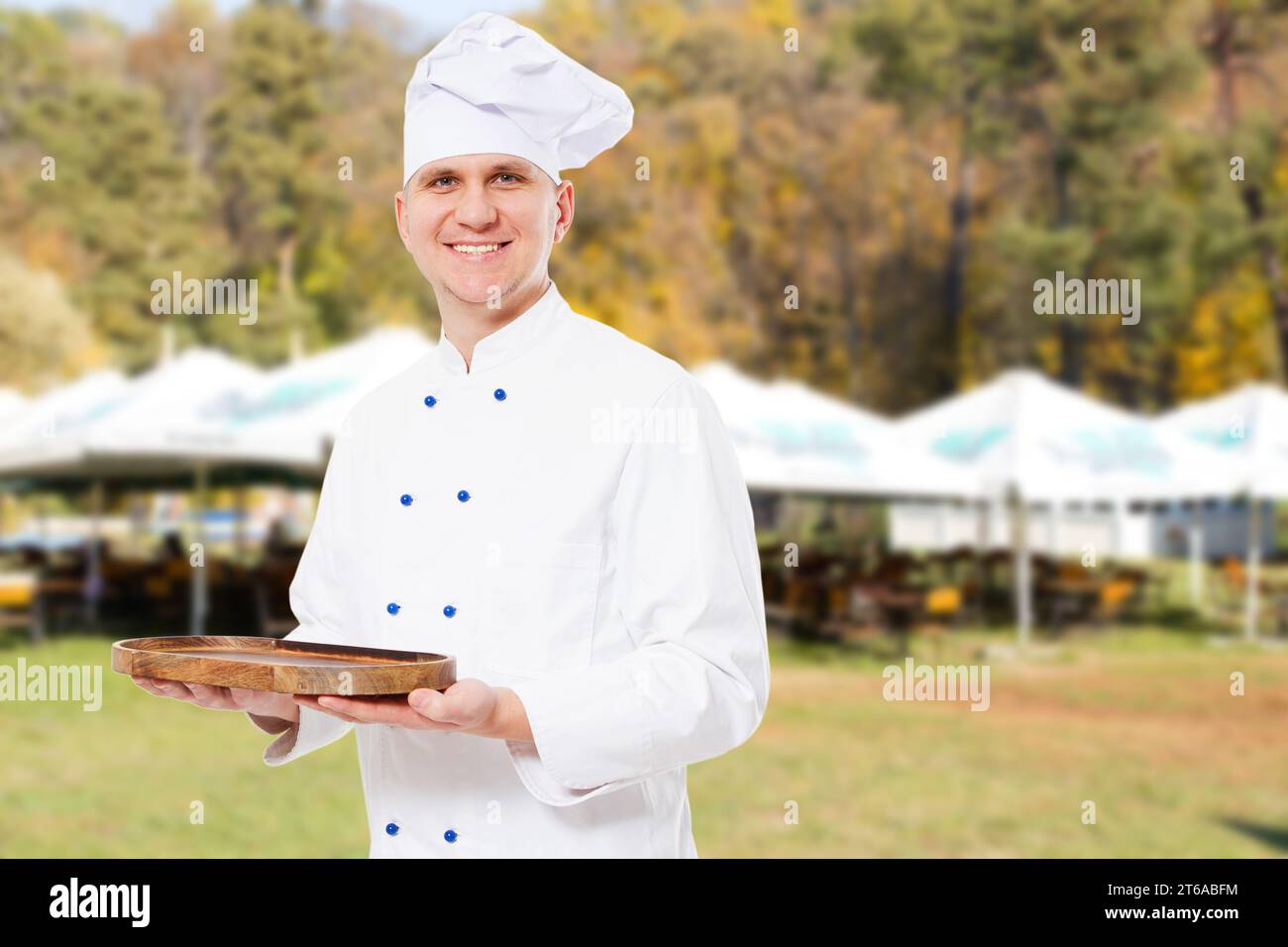Happy smiling chef preparing a meal mock up in empty wooden tray Stock ...