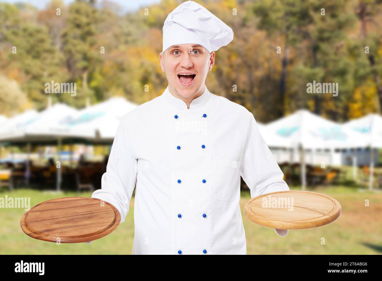 Happy teen male chef with pizza boards mock up Stock Photo - Alamy