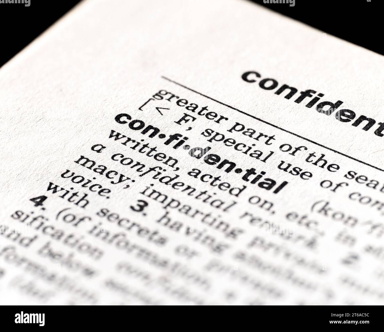 Closeup dictionary definition of the word confidential Stock Photo - Alamy