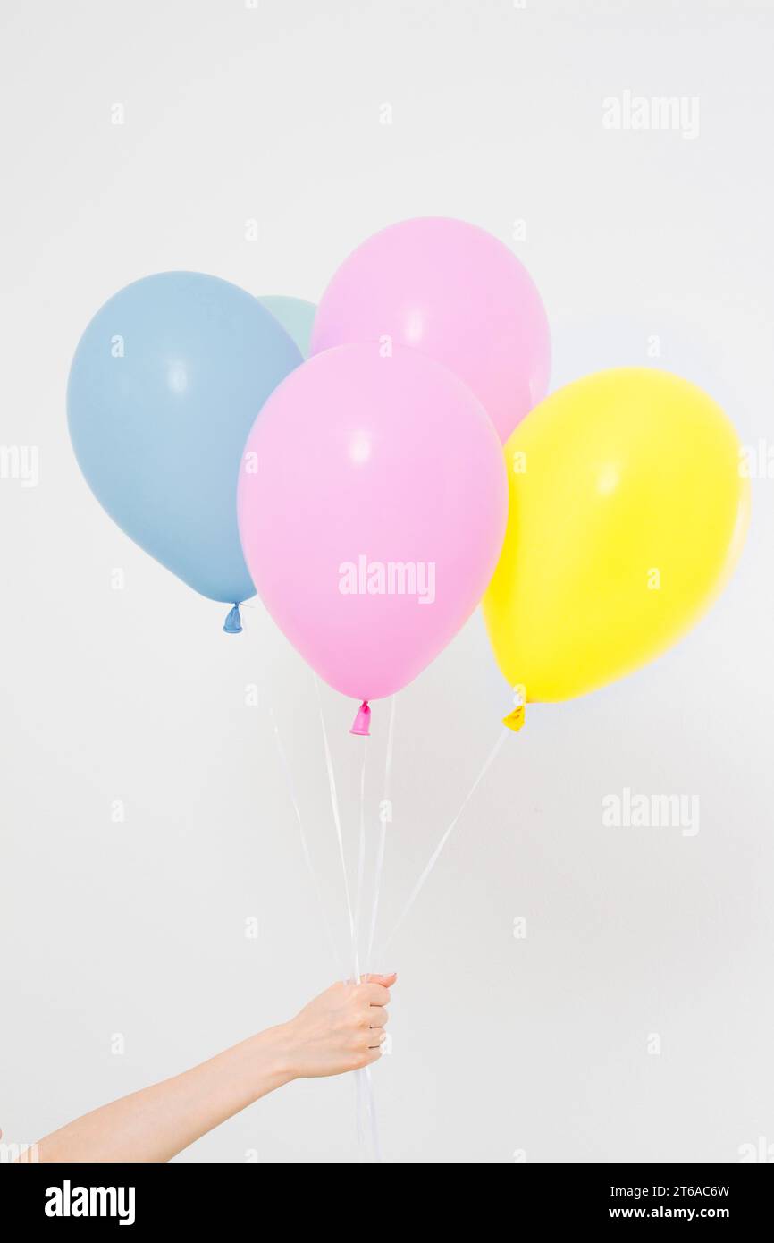 Hand holding balloons. Holiday concept. Colorful party balloons ...