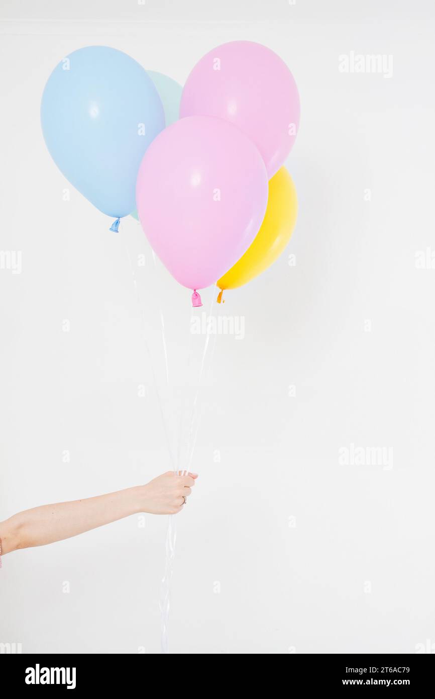Hand holding balloons. Holiday concept. Colorful party balloons ...