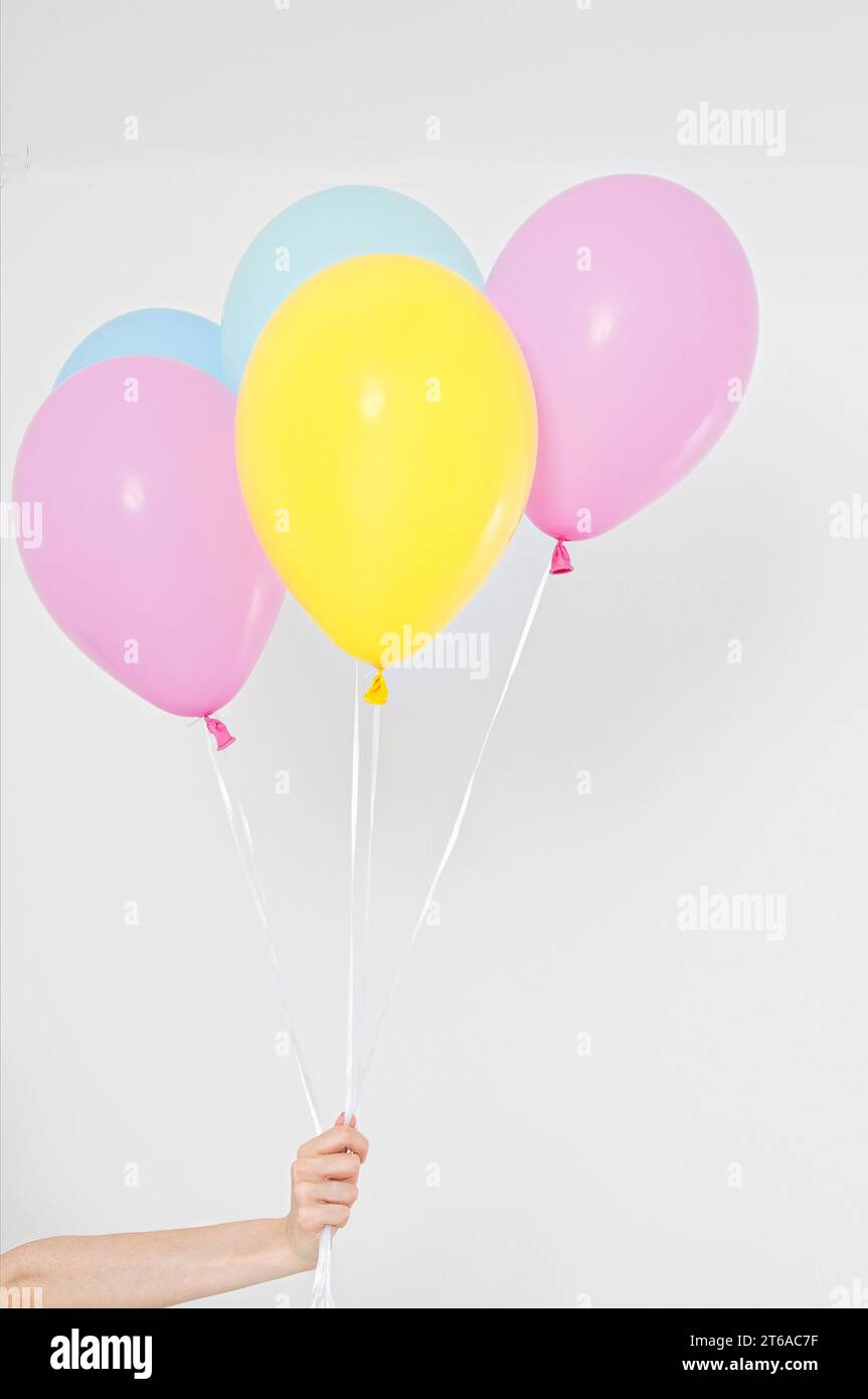 Hand holding balloons. Holiday concept. Colorful party balloons ...