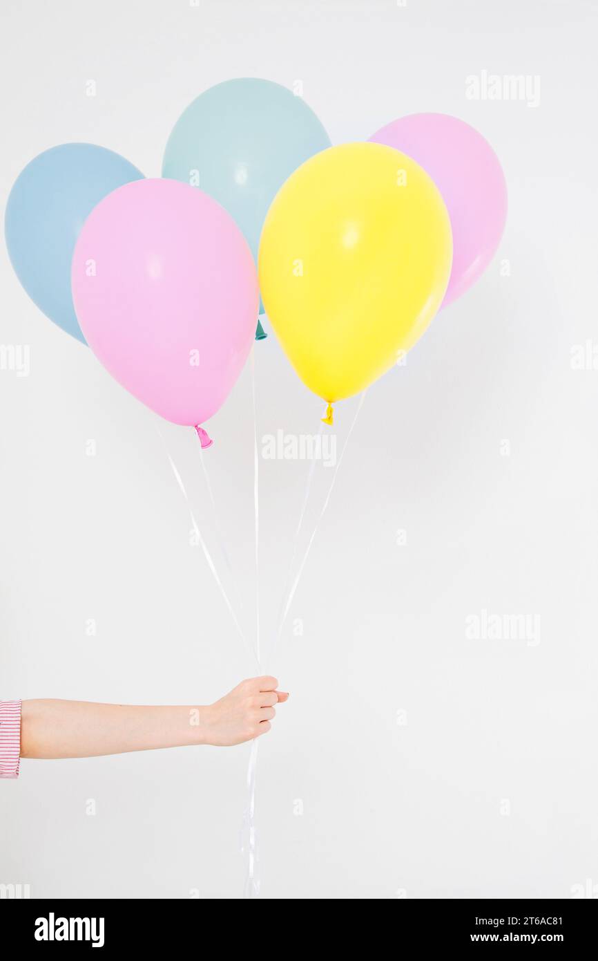 Hand holding balloons. Holiday concept. Colorful party balloons ...