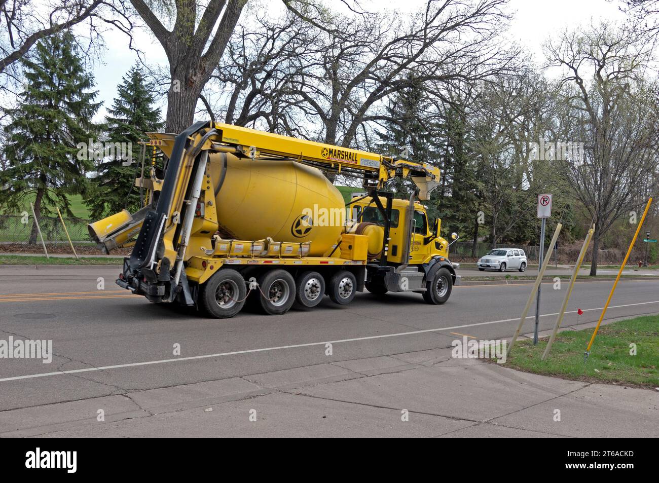 Large yellow Marshall Concrete Products cement truck delivering a load ...