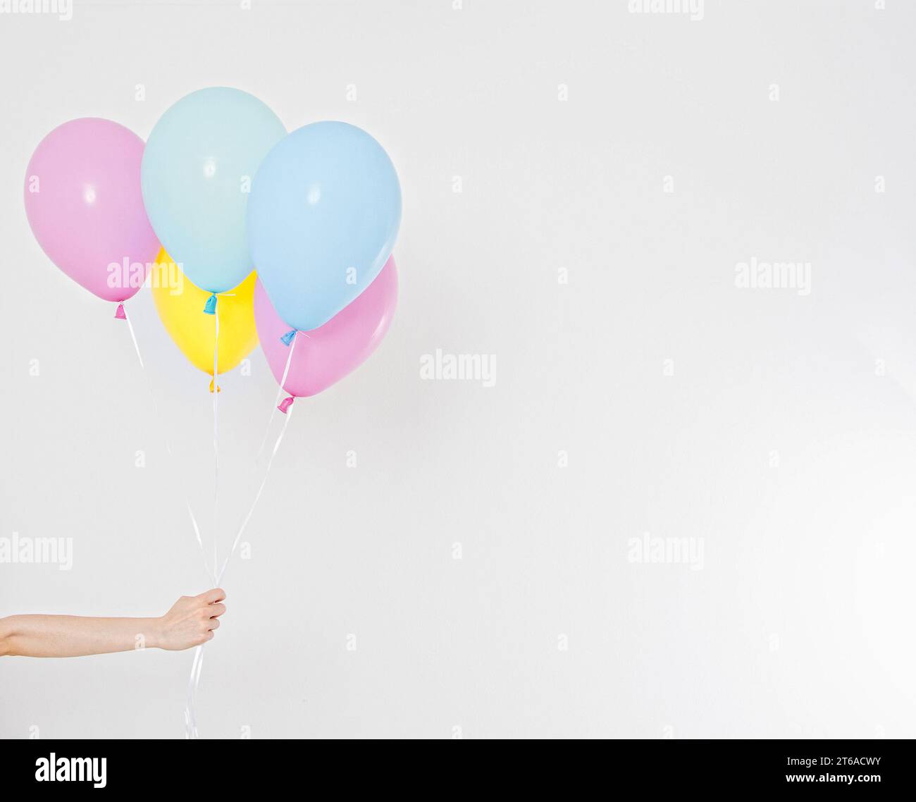 Hand holding balloons. Holiday concept. Colorful party balloons ...