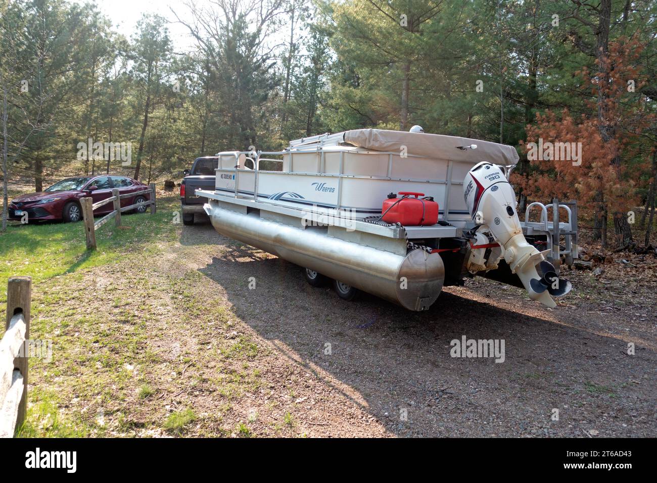 A Weeres pontoon boat powered by an Evinrude 90 outboard motor on a ...