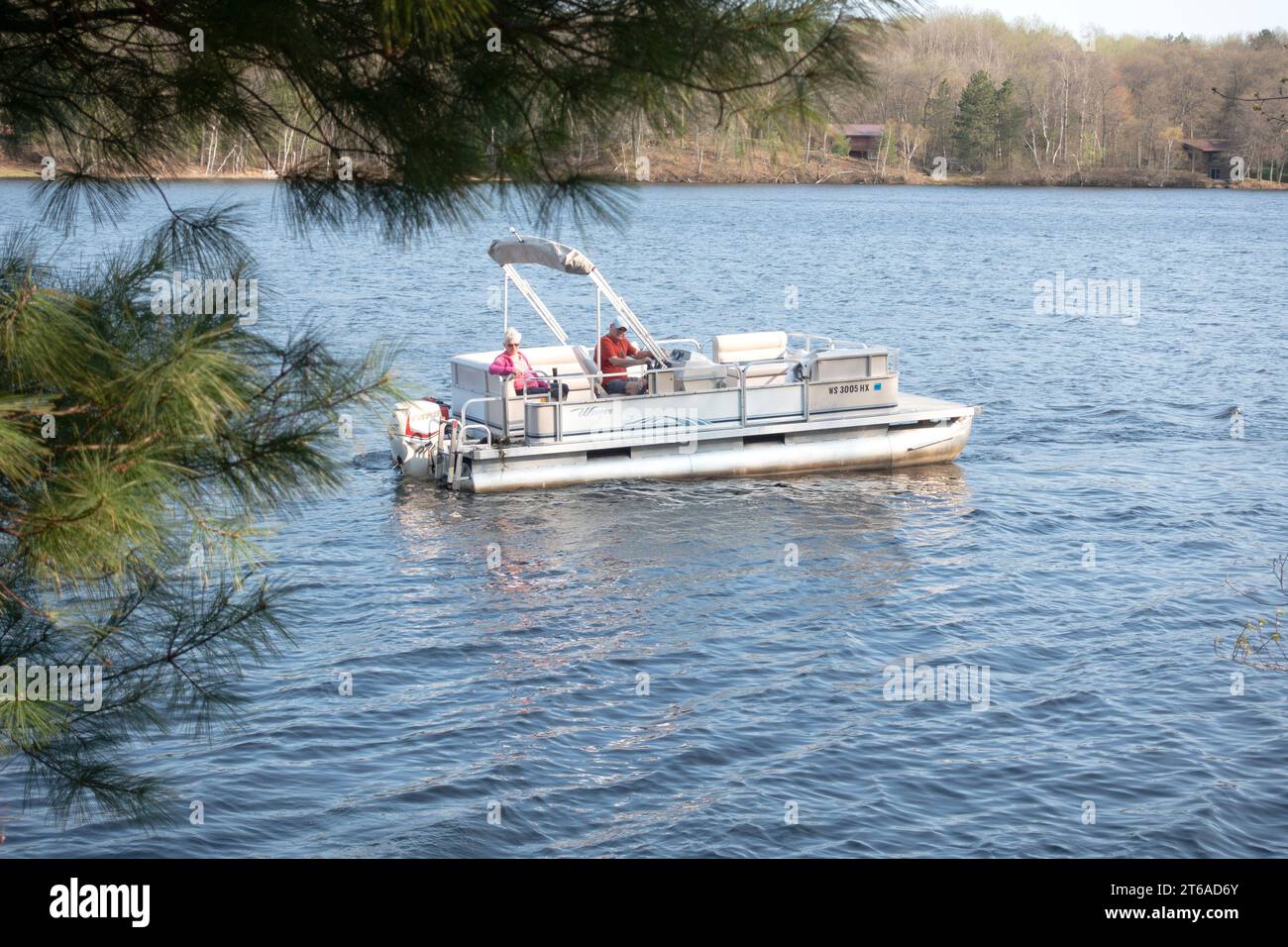 Couple enjoying their ride on a Weeres Pontoon Boat powered by Evinrude ...