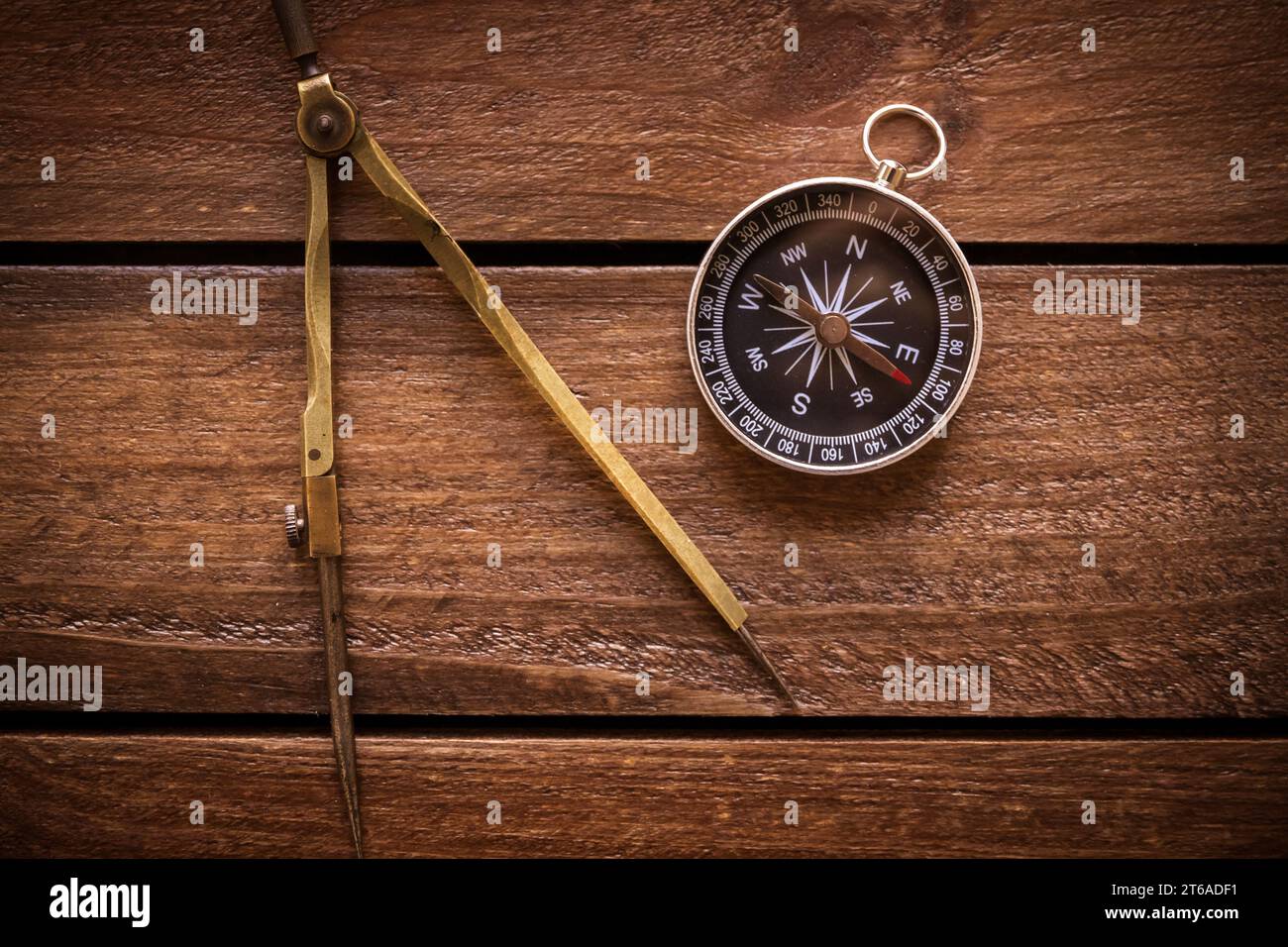 Vintage drawing and navigational Compass on a rustic wooden board Stock ...