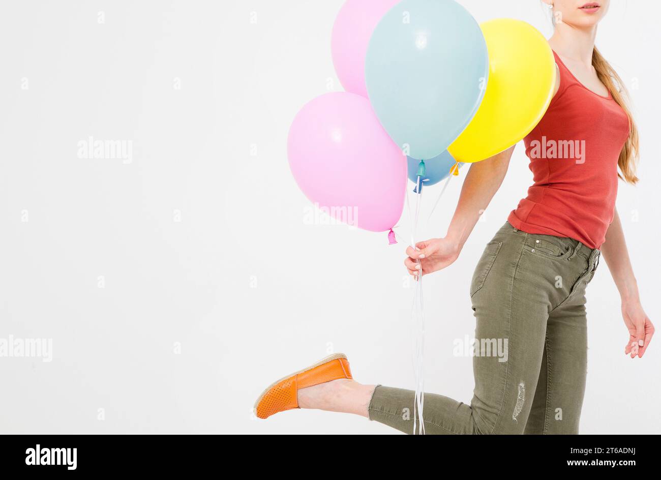 young woman girl running with colored balloons isolated on white ...