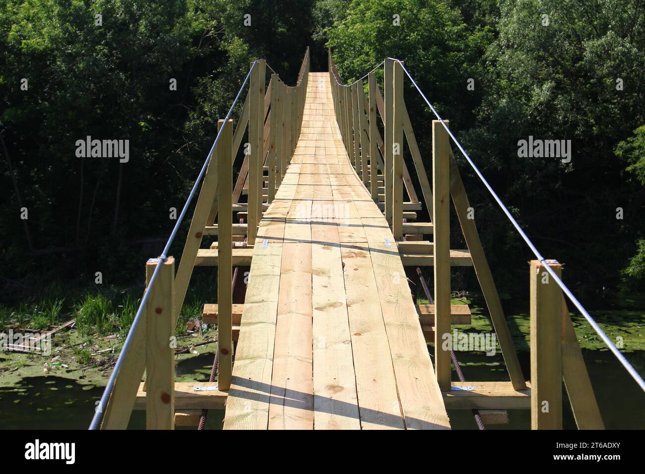 New wooden suspension bridge over the river for pedestrians in the ...