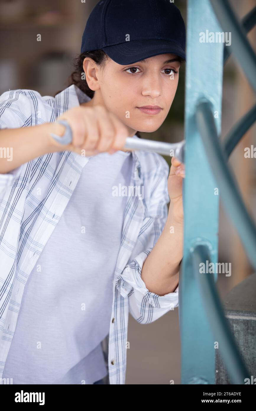 female worker using spanner to tighten bolt on railings Stock Photo - Alamy