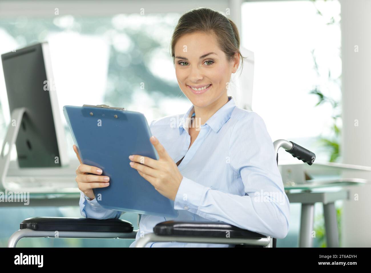 portrait of attractive secretary in a wheelchair Stock Photo - Alamy