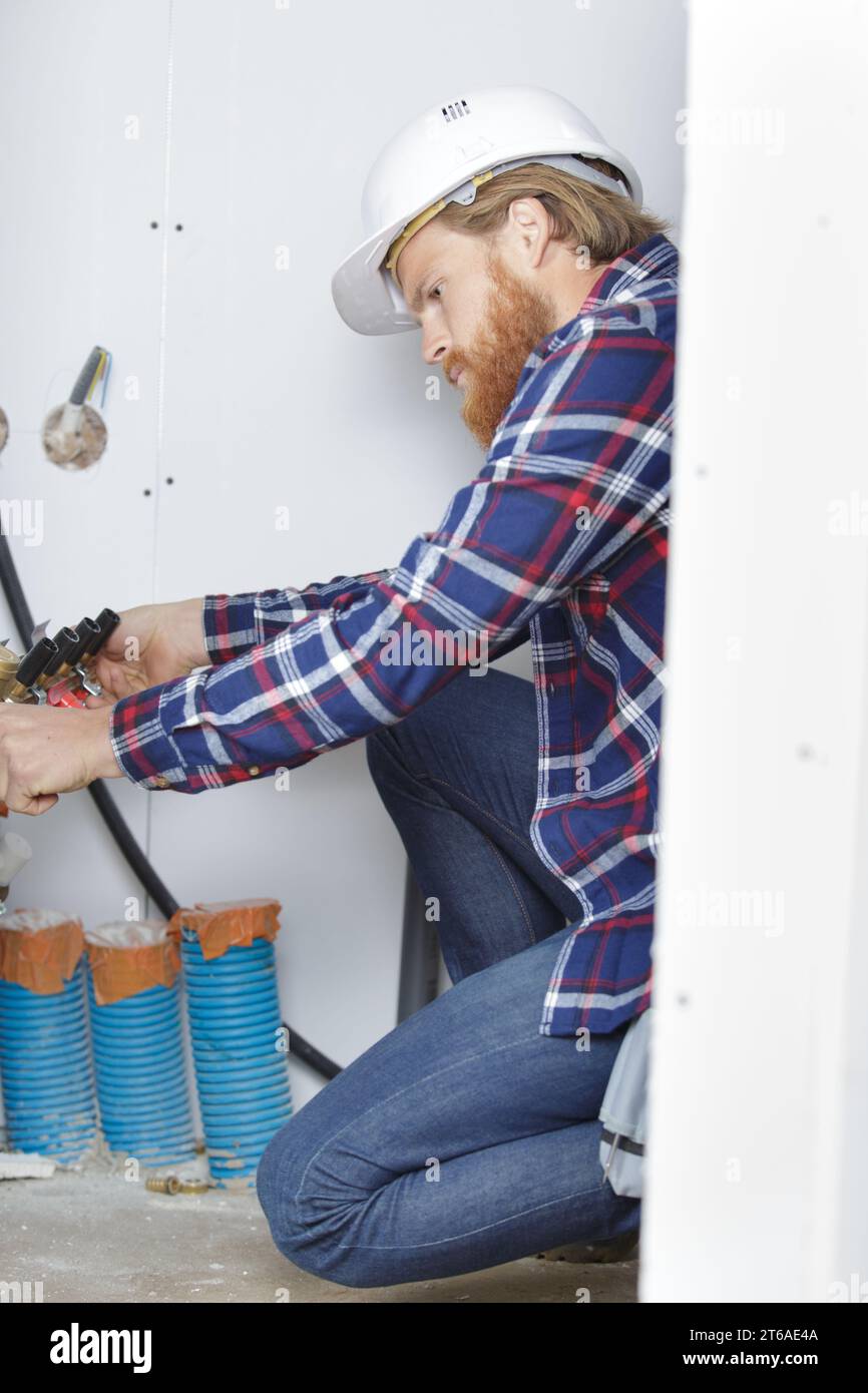 man during installation of pipes indoors Stock Photo - Alamy