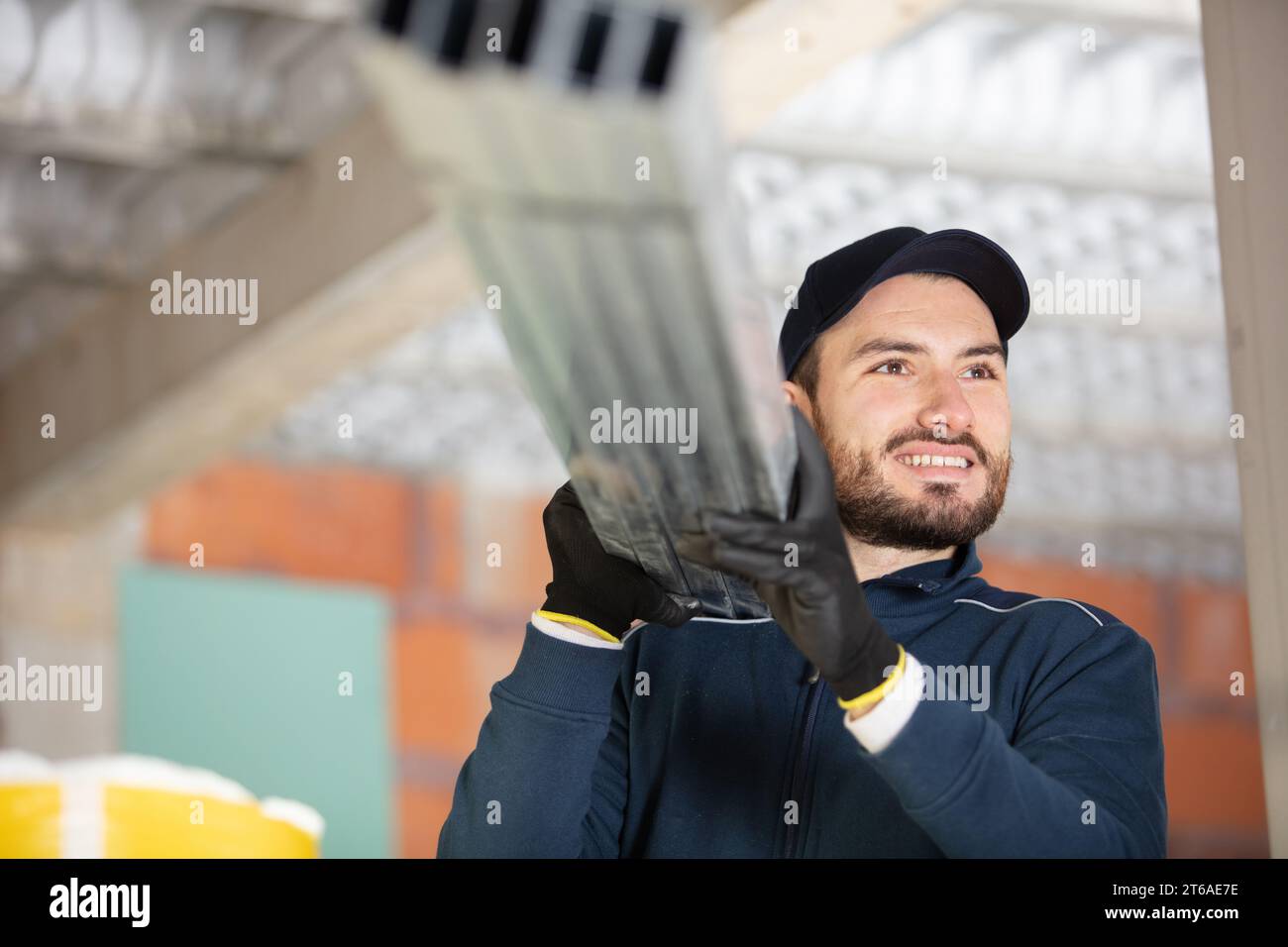 construction worker carrying reinforcement rods at building site Stock ...