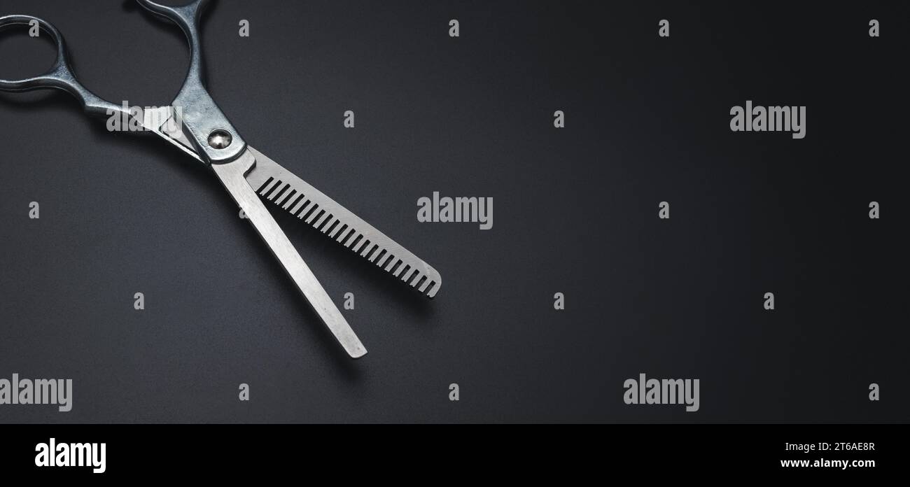 Professional Haircutting Scissors. Open hairdresser scissors on a black ...