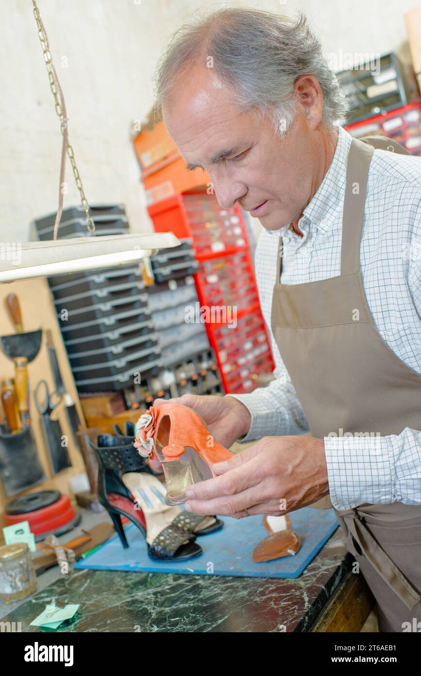 a shoe repairer at work Stock Photo - Alamy