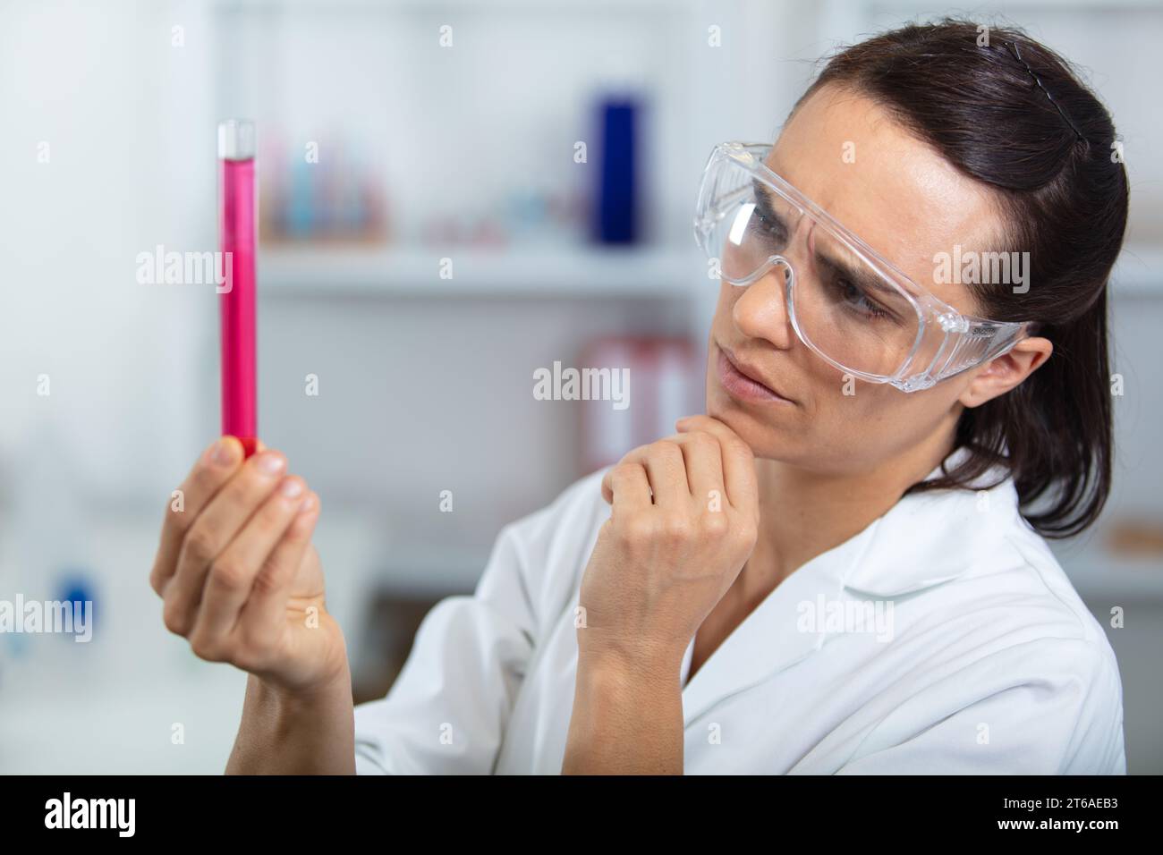 young attractive female scientist in the scientific chemical laboratory ...