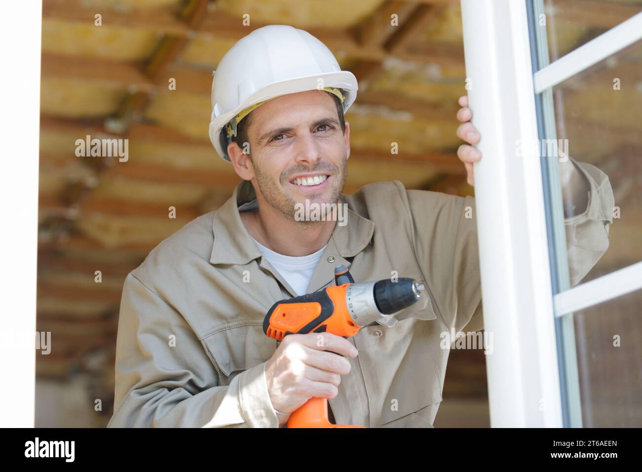 happy smiling constructor wearing helmet Stock Photo - Alamy