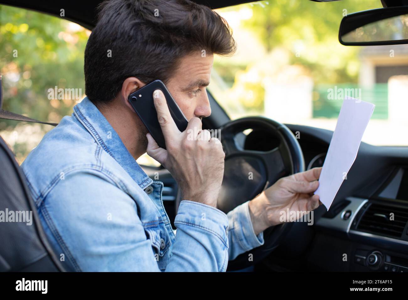 driver using phone with hand while looking at the map Stock Photo - Alamy